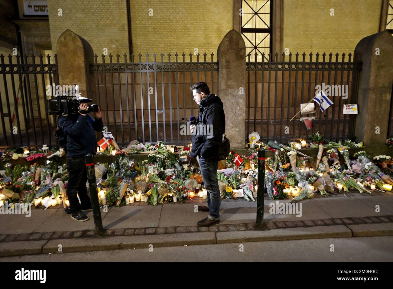 Flowers are laid outside the synagogue in Copenhagen after the shooting ...