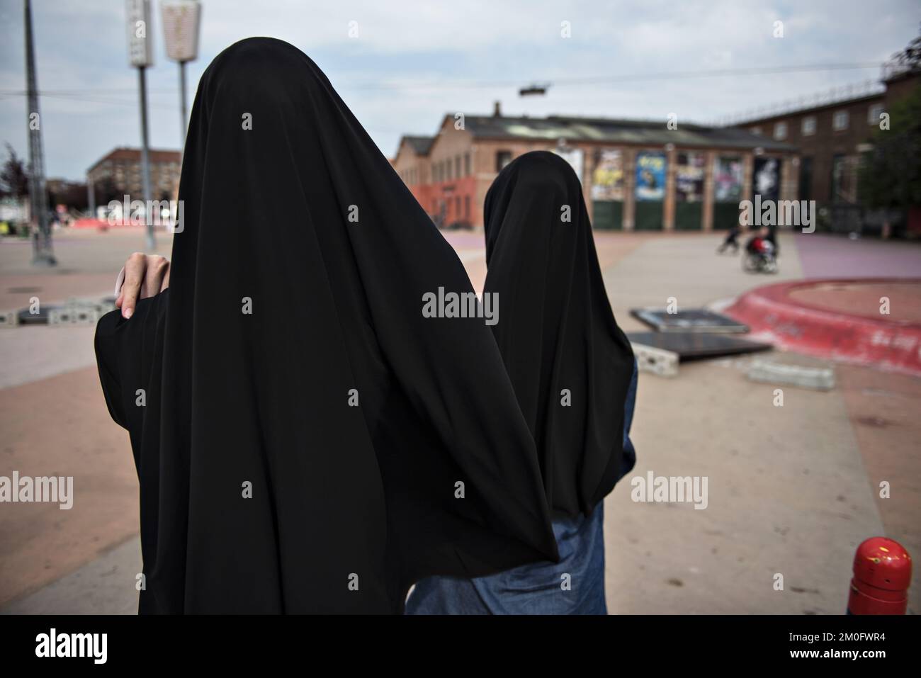 Two muslim girls pass by the Red Square on Norrebro Stock Photo - Alamy