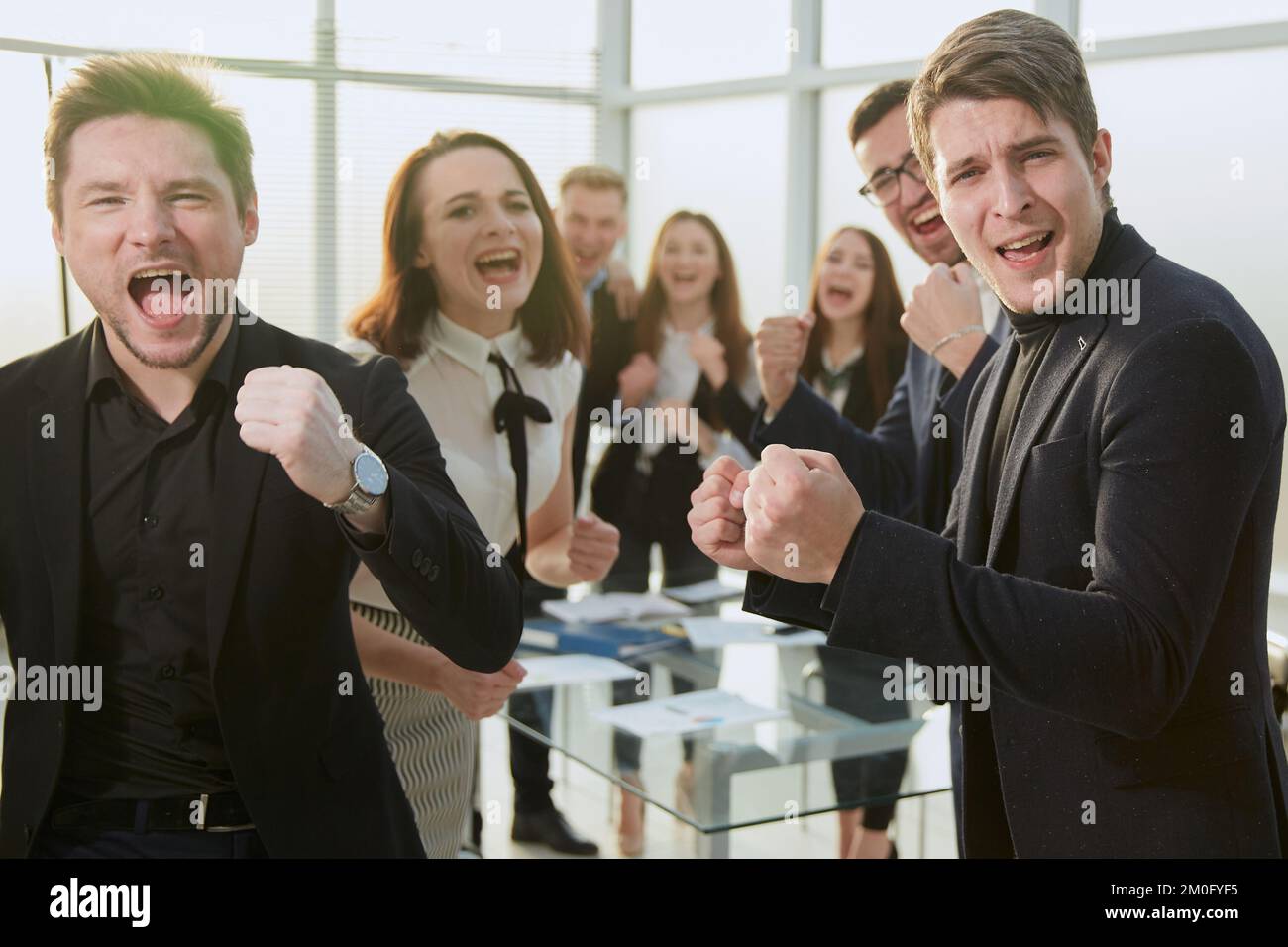 happy business team is standing in the office applauding Stock Photo ...