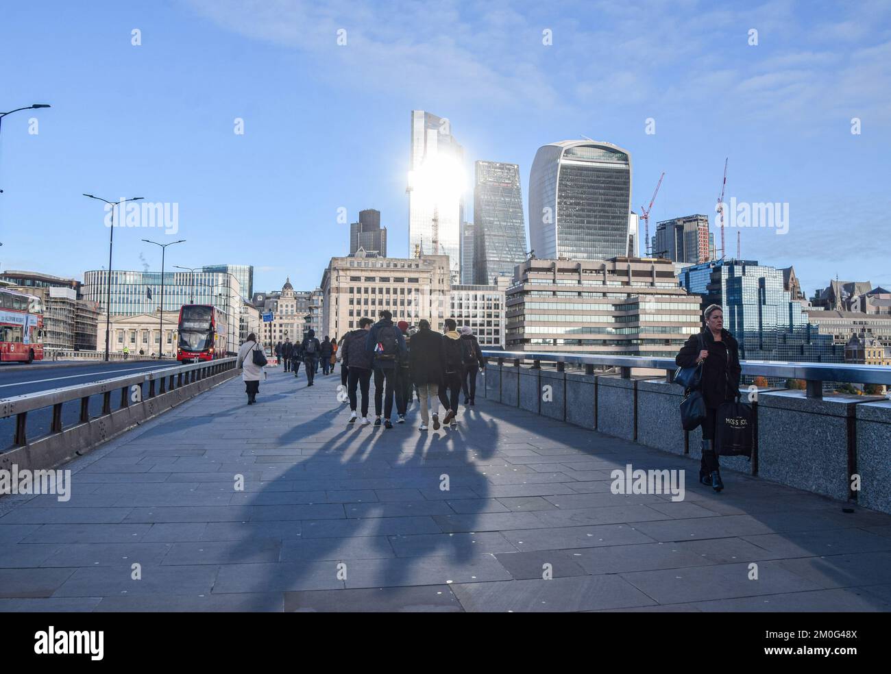 London, UK. 06th Dec, 2022. People walk across London Bridge past the ...