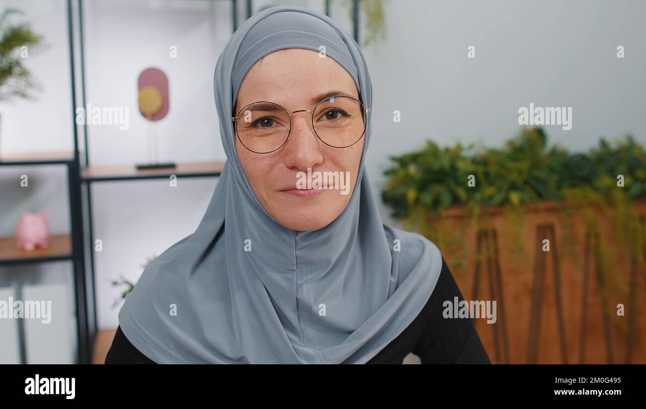 Portrait of happy calm young muslim business woman wearing hijab ...