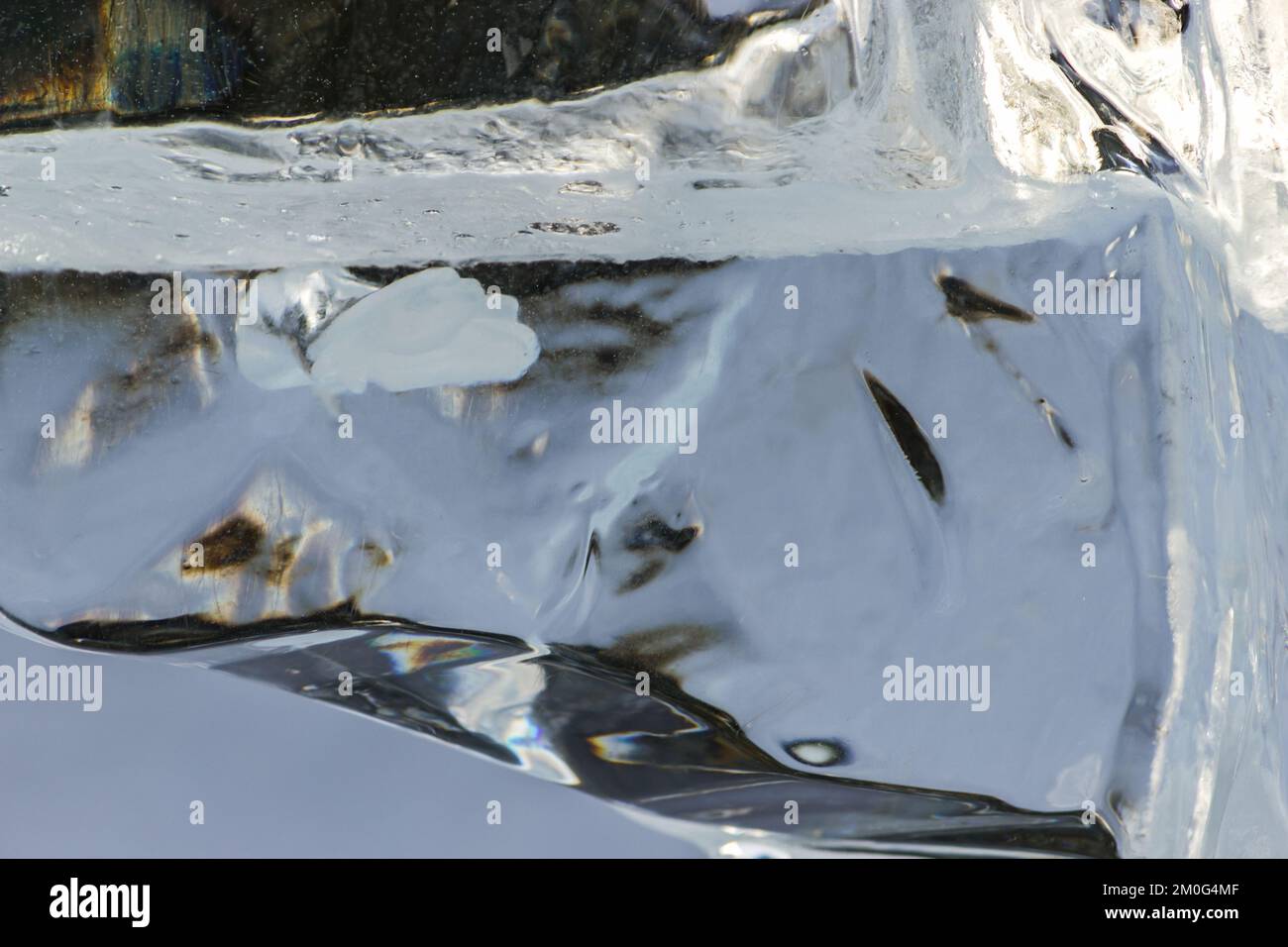 A block of ice with fractured components enhanced by light shining ...