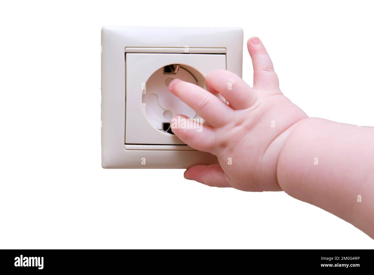 Baby toddler reaches into the electrical outlet on the home wall with ...