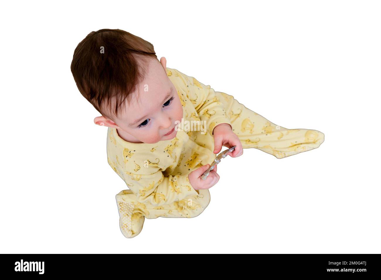Toddler baby boy plays with medicines in a package while sitting on the ...