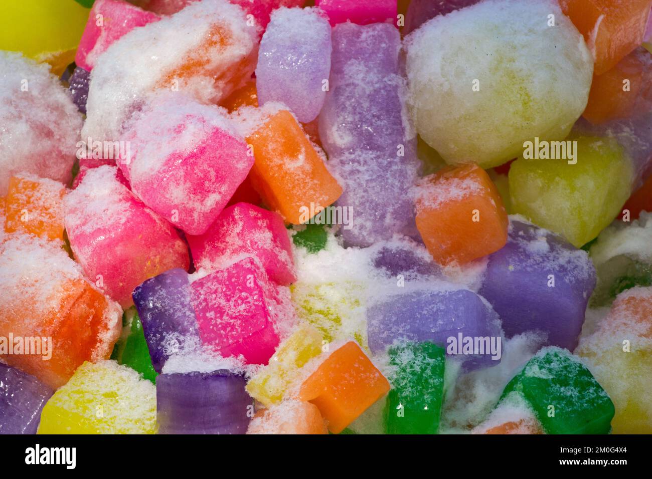 Ice cubes are stained various colors and covered with snow during an ...