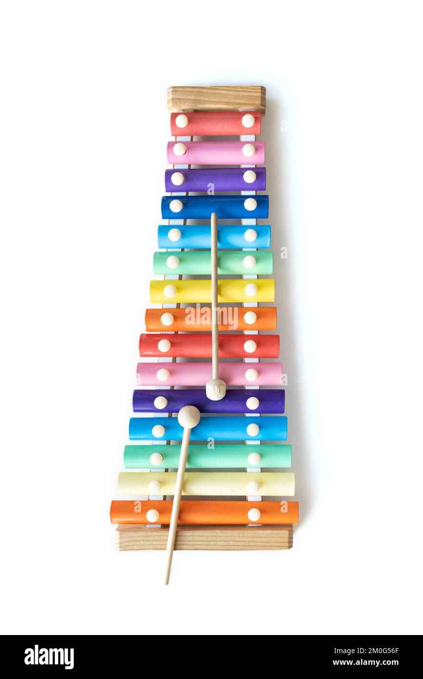 Two wooden sticks on colorful rainbow xylophone instrument toy isolated ...