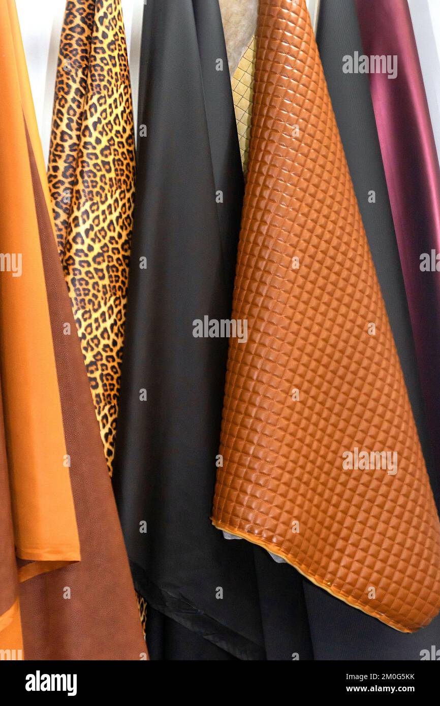 Textile color samples and patterns on wall of fashion design studio ...