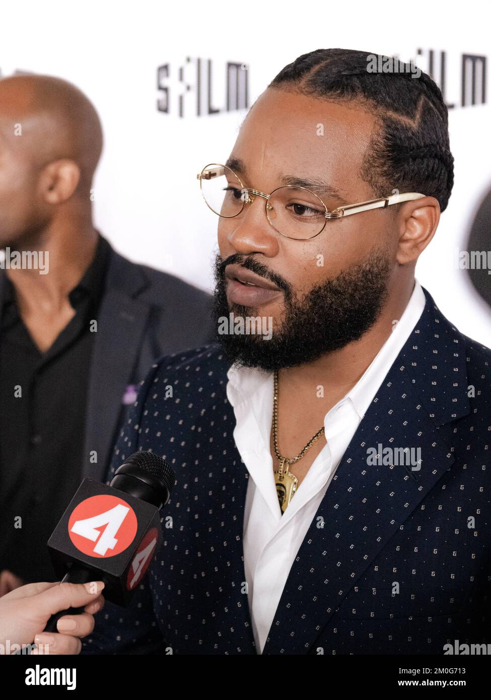 Ryan Coogler being interviewed on the red carpet arrivals at the 2022 ...