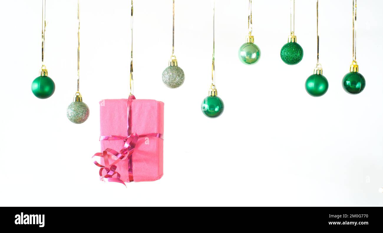 christmas balls in a row, wrapped present, on white background, merry ...