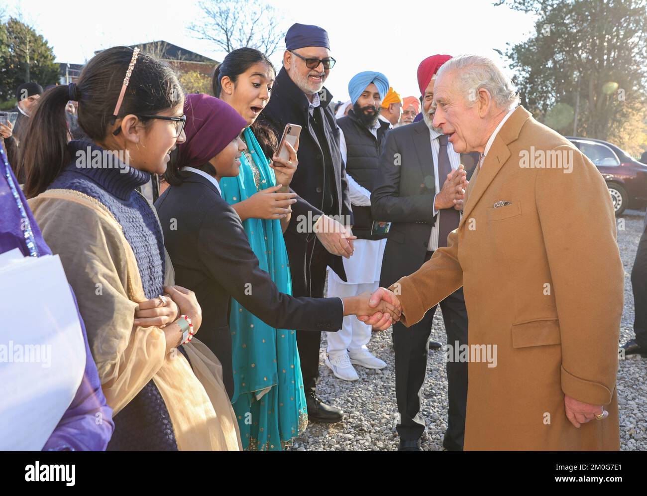 King Charles III shakes hands and speaks to congregation members after ...