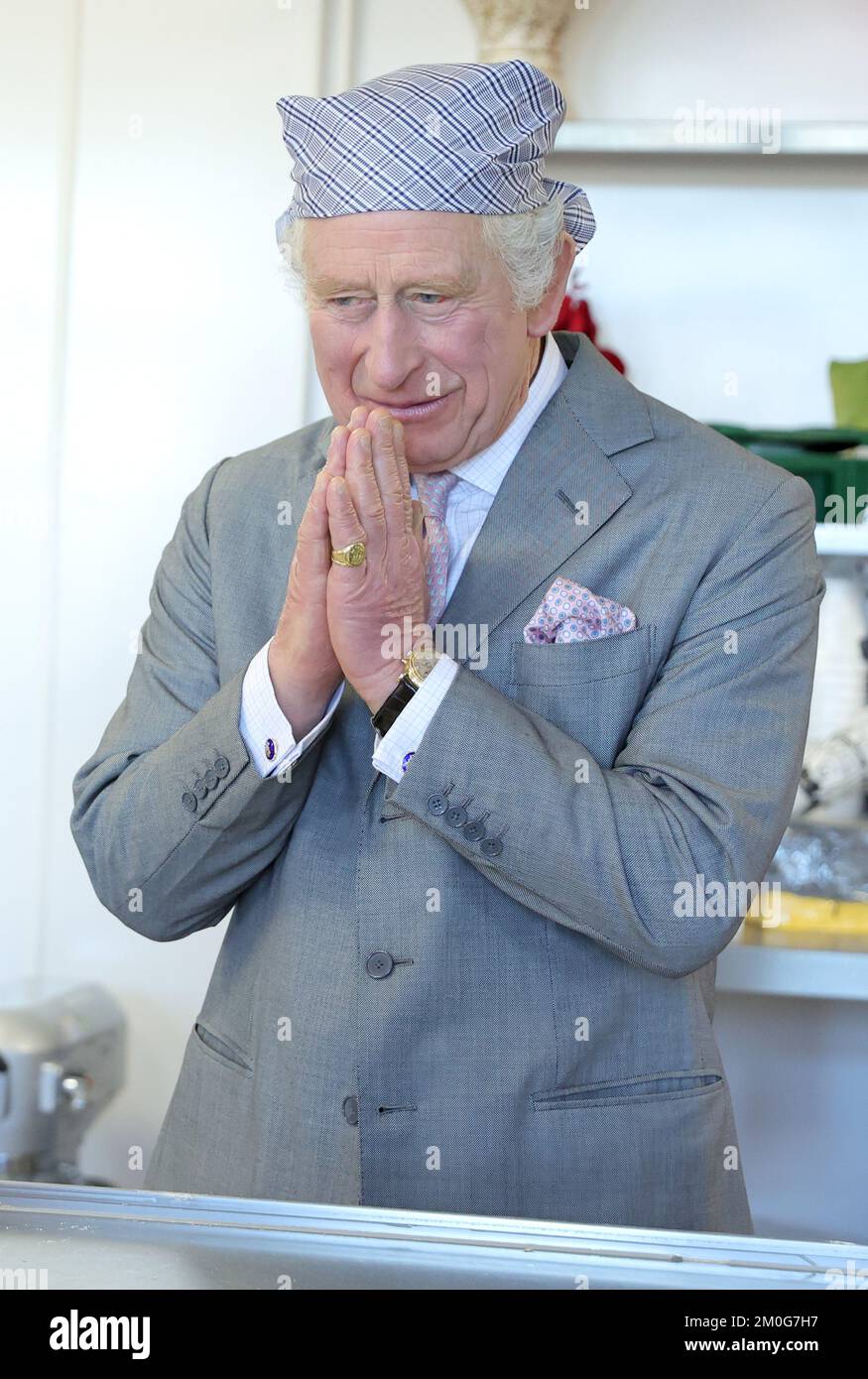 King Charles III makes the traditional namaste gesture during a visit ...