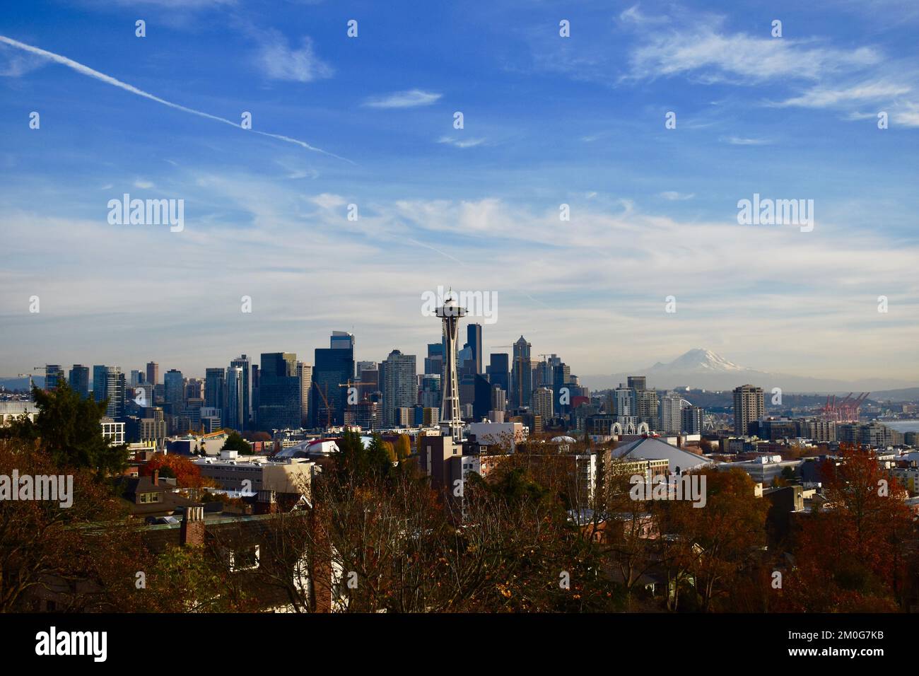 An aerial shot of the Space Needle in Seattle with Mount Rainier in the ...