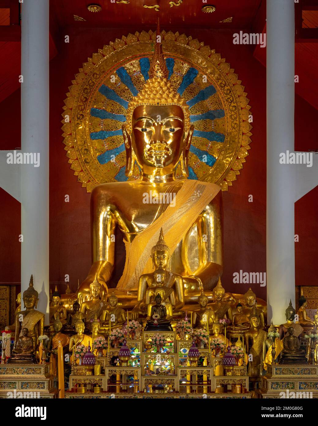 View of main golden Buddha and smaller gilded statues inside main ...