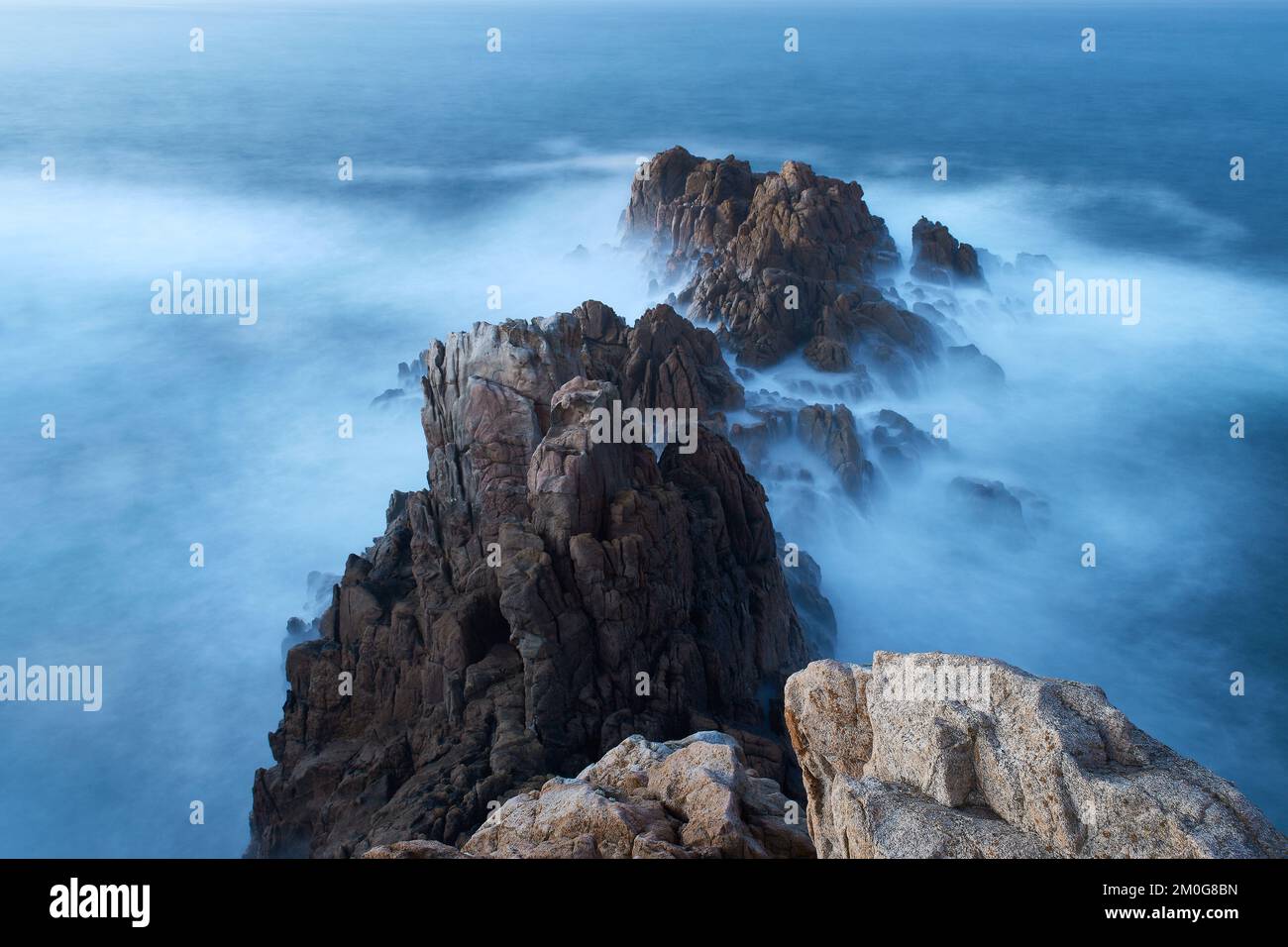 A long exposure shot of the rocks on the beach Stock Photo - Alamy