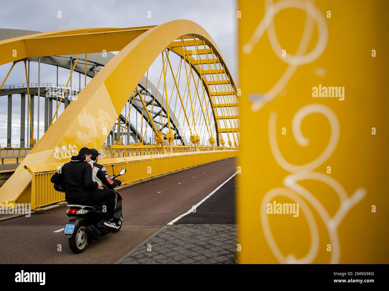 UTRECHT - A moped rider without a helmet on the Hogeweide Bridge in ...