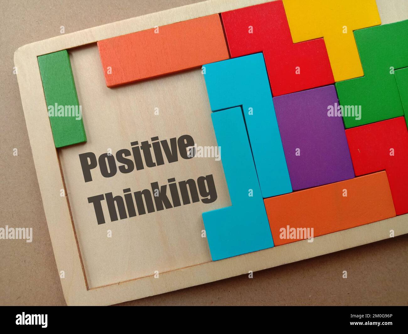 The colorful wooden puzzle pieces with POSITIVE THINKING text on beige ...