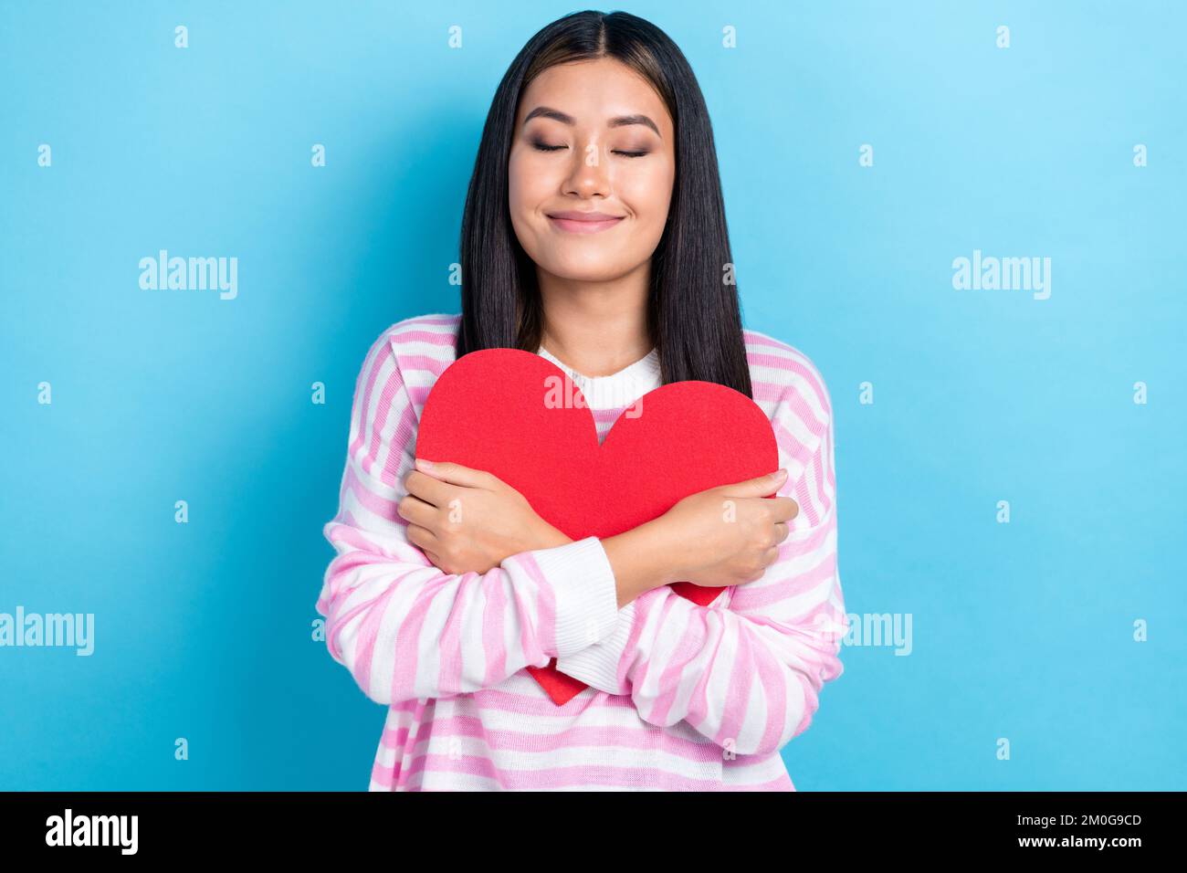 Photo of lovely dreamy lady wear striped sweater closed eyes hugging ...