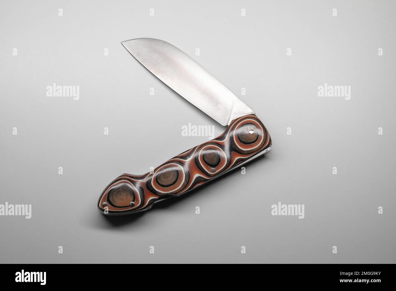 Jackknife with half opened sharp steel blade and polymer handle with ...