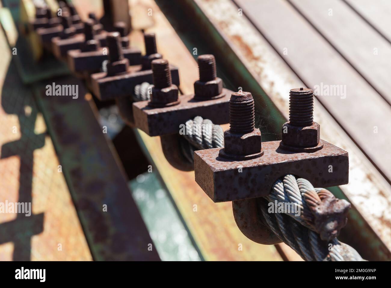 Rope with rusty bolt clamps, cable-stayed bridge details close up photo ...