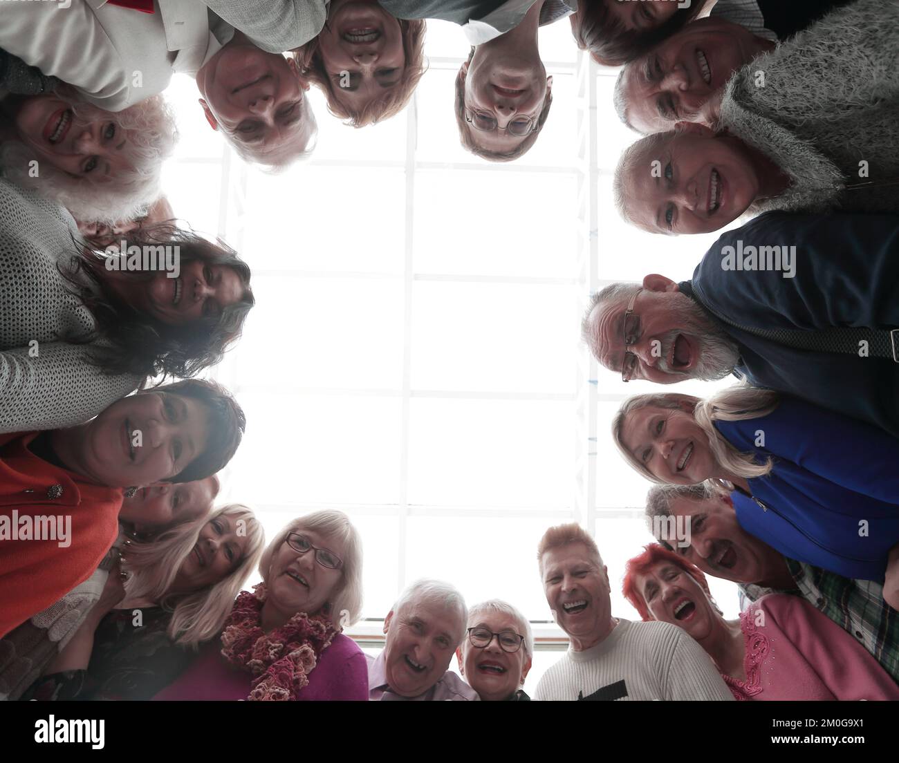 Happy people looking down at camera Stock Photo - Alamy