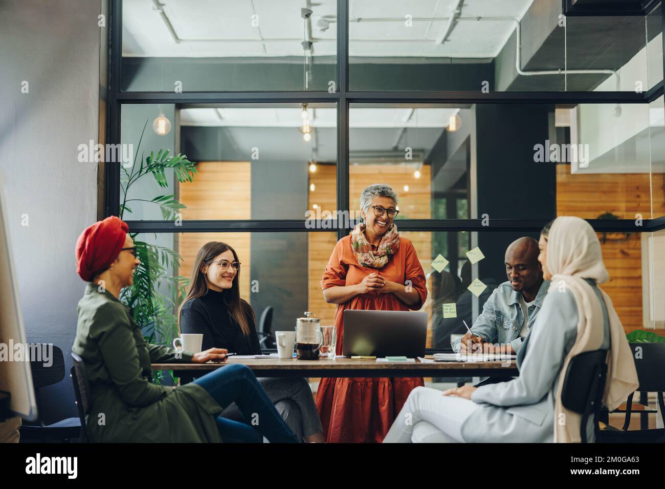 Successful businesspeople smiling happily during a meeting in a ...