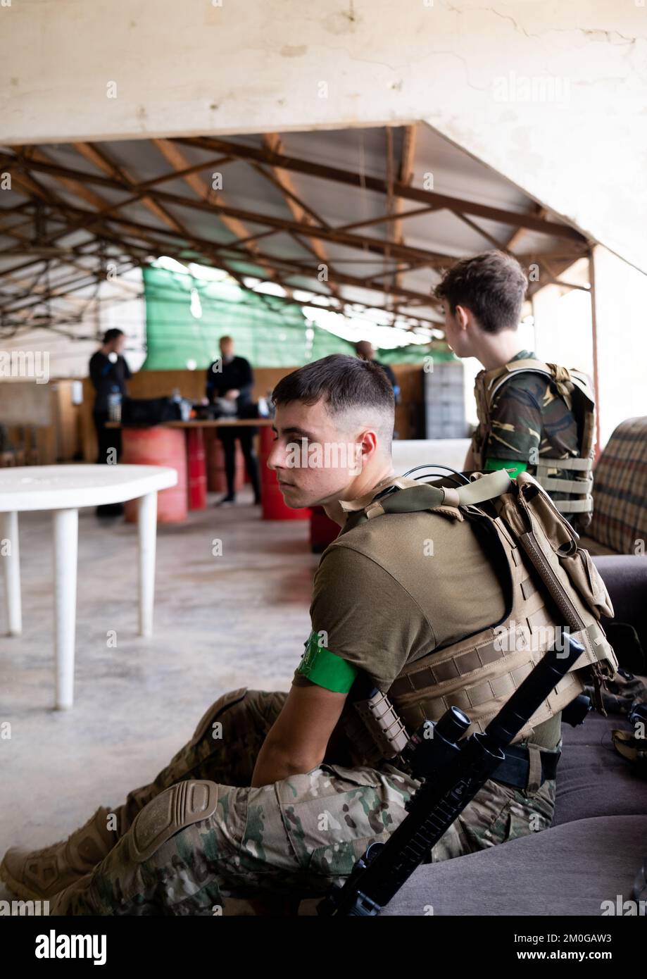Two teenagers equipped with military clothing eagerly await the start ...
