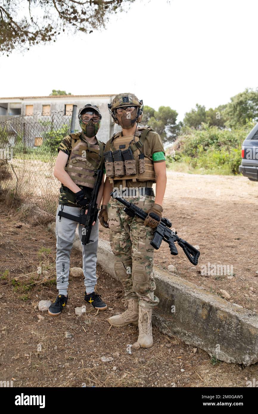 Pair of teenagers looking at the camera with their replicas at the ...