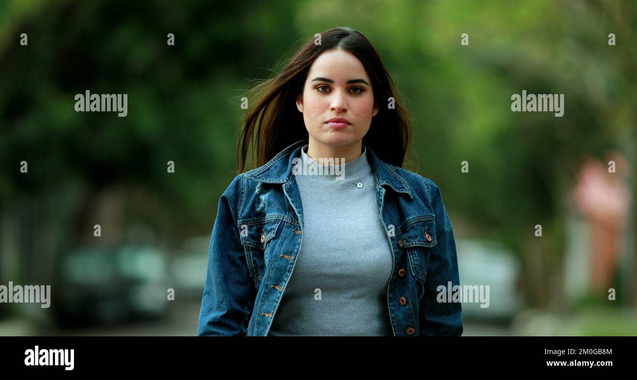 Confident young woman walking forward towards camera portrait Stock ...