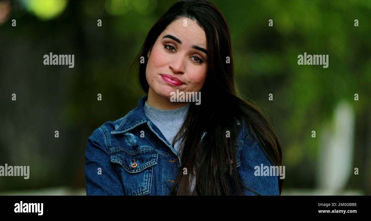 Angry judgemental young woman standing outside feeling anger and ...