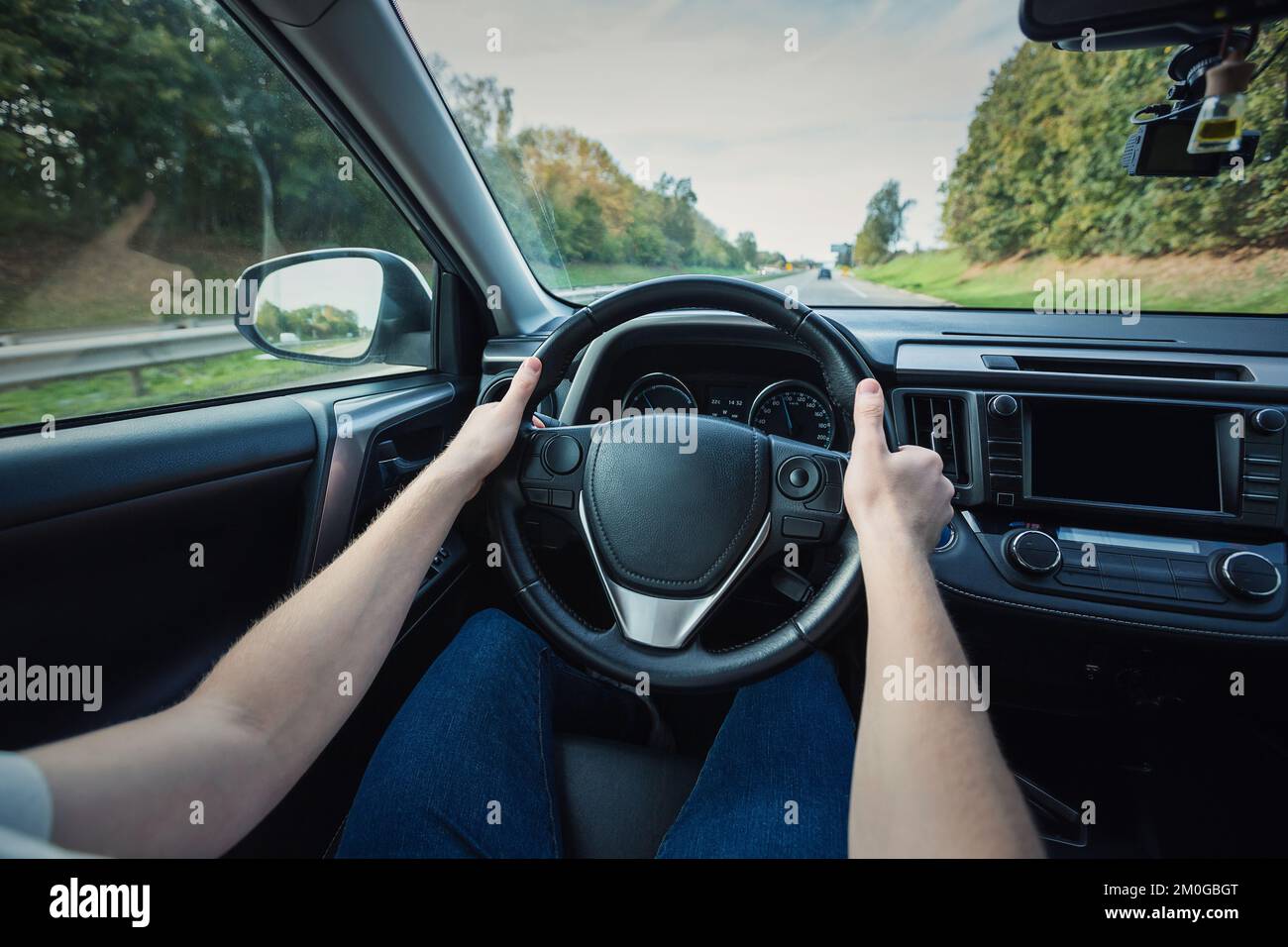 Closeup person hands on the steering wheel, confident driving car on ...