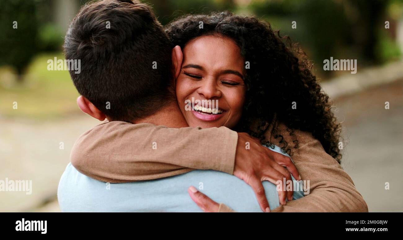 Black woman running and embracing man. Joyful girl hugging boyfriend ...