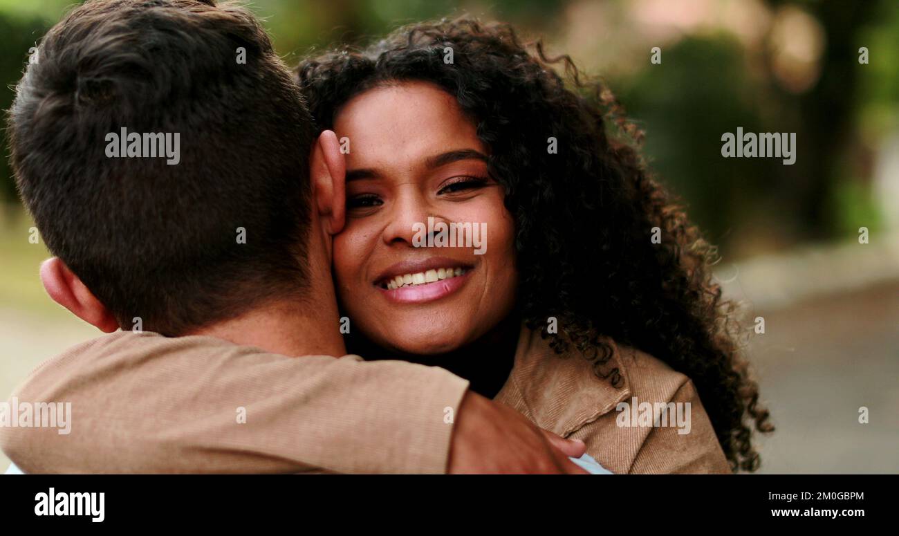 Black woman running and embracing man. Joyful girl hugging boyfriend ...
