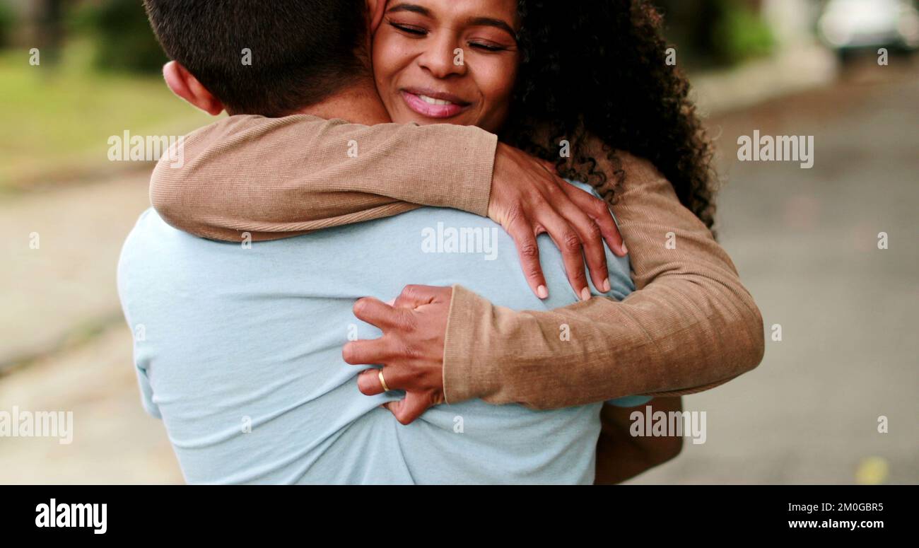 Black woman running and embracing man. Joyful girl hugging boyfriend ...