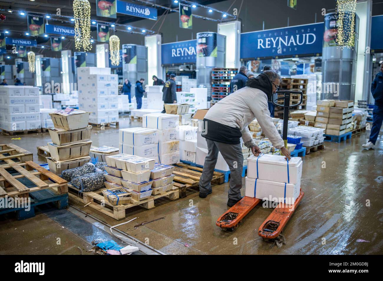 Staff work in the seafood pavilion at Rungis International wholesale ...