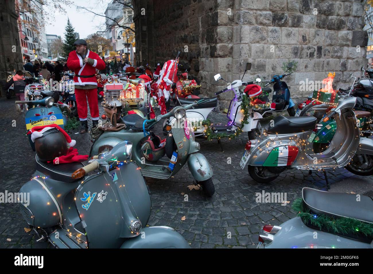 members of Vespa scooter clubs dressed as Santas during a ride through ...