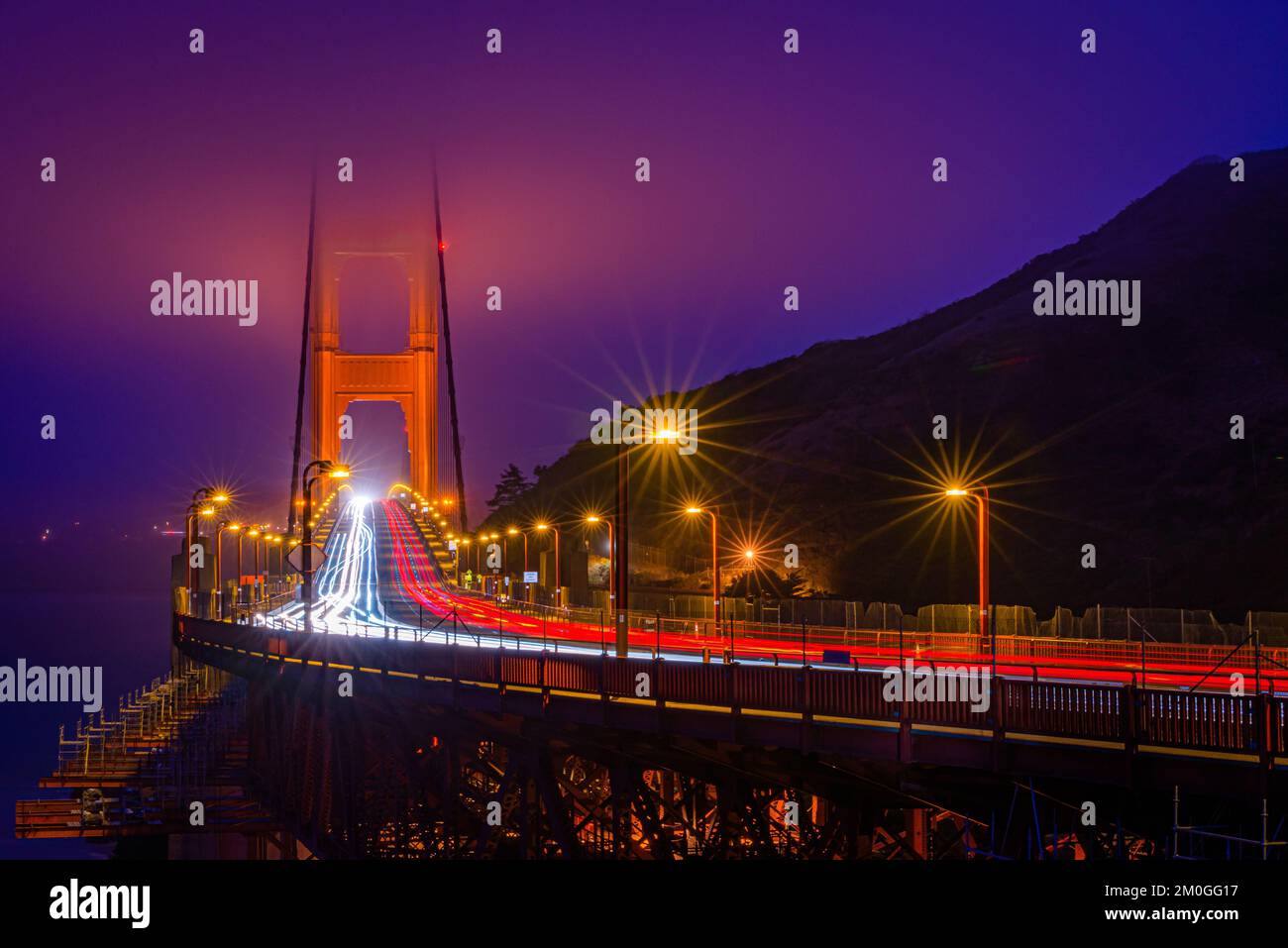Colorful lights of cars and lamp posts on the Golden Gate Bridge during ...