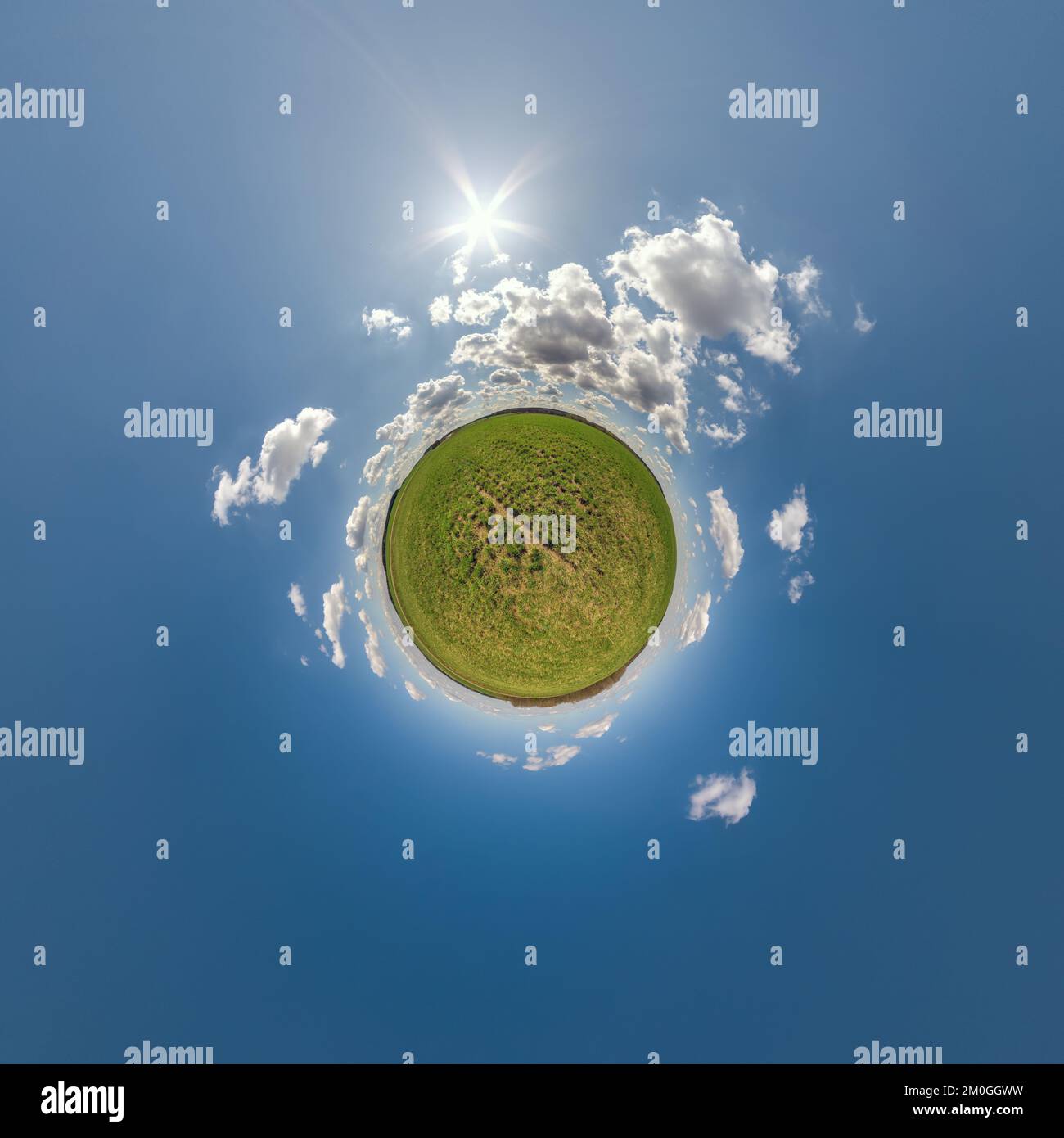 green tiny planet in blue sky with beautiful clouds with transformation ...