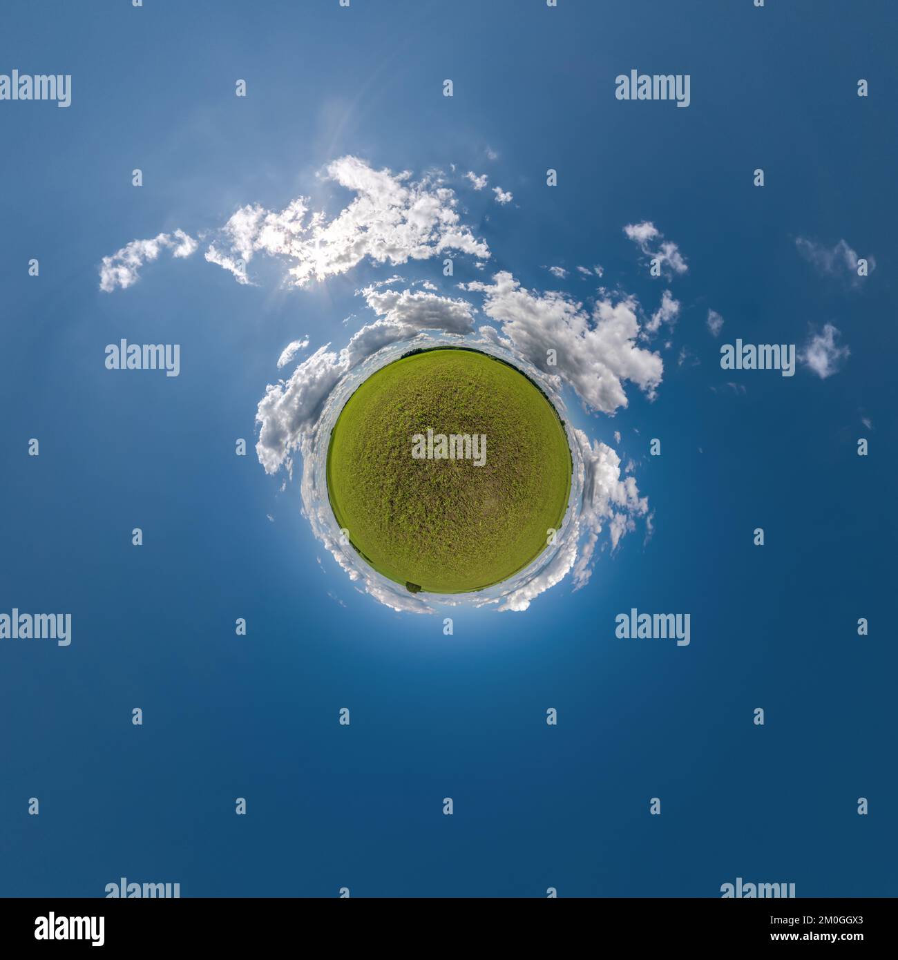 green tiny planet in blue sky with beautiful clouds with transformation ...