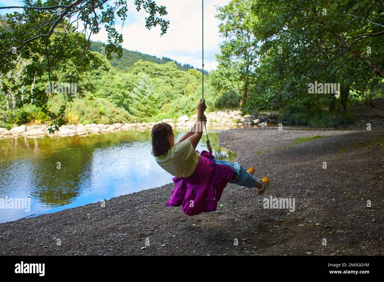 Jump into the water. A woman is resting on the lake. A swing from a ...