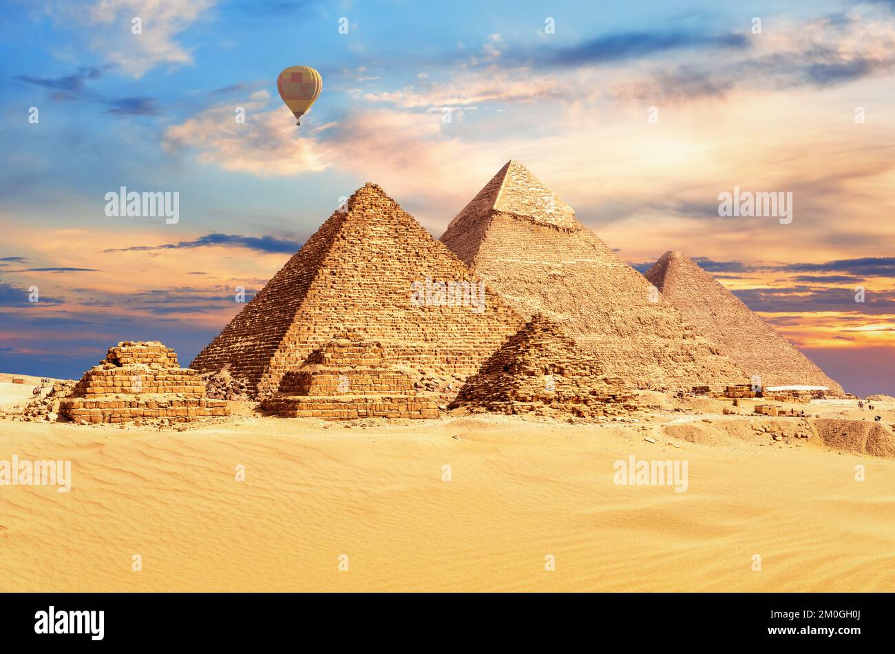 The Great Pyramids of Egypt under a colorful desert sky, Giza Stock ...