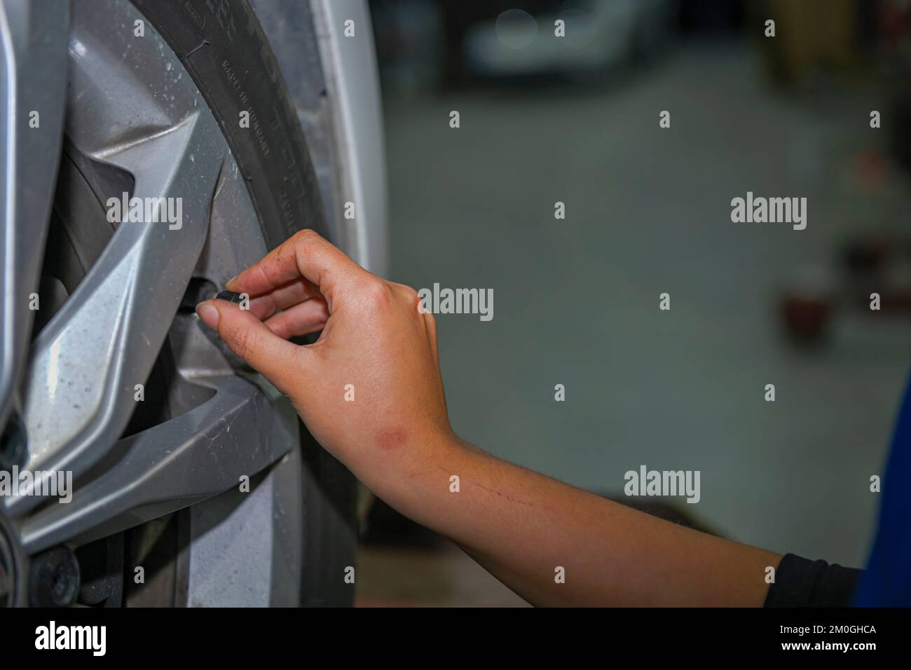 Female hands removing the valve from a wheel, for inflation Stock Photo ...