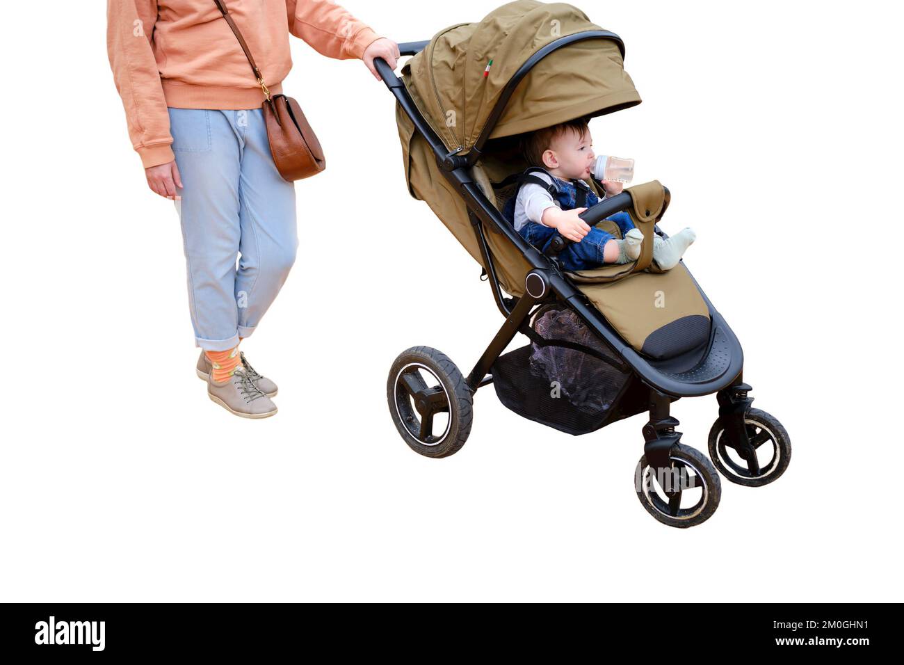 Woman mother walks with toddler baby boy sitting in a stroller ...