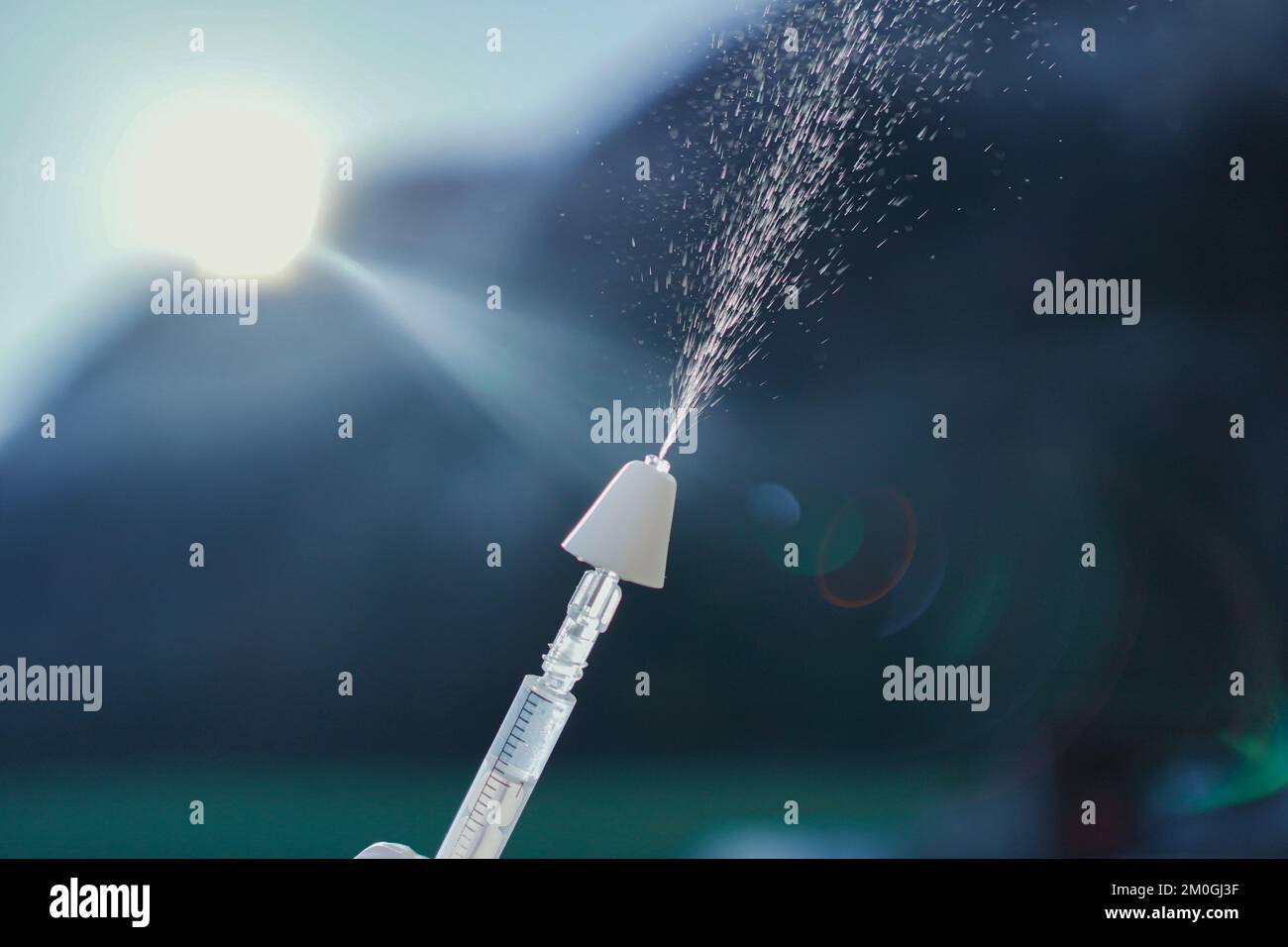 Hand using a syringe with a mucosal atomization decive (MAD) for ...