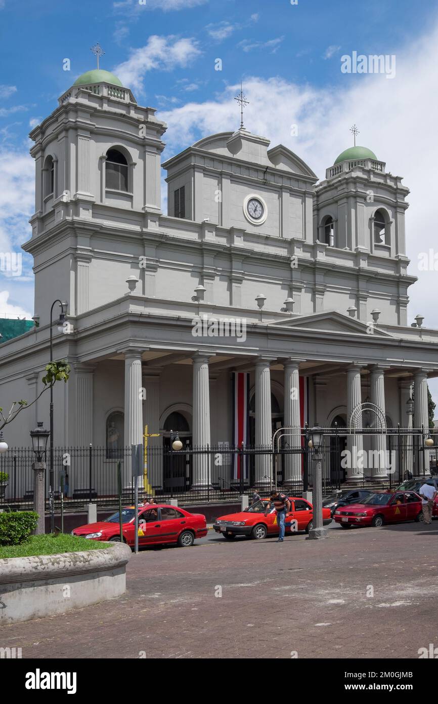 Taxis and facade of the cathedral of San José in the capital of Costa ...