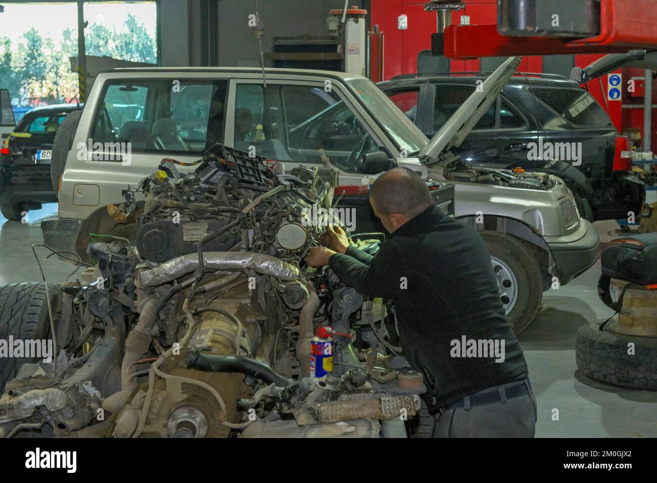 Auto mechanic working on car engine in mechanic garage Stock Photo - Alamy