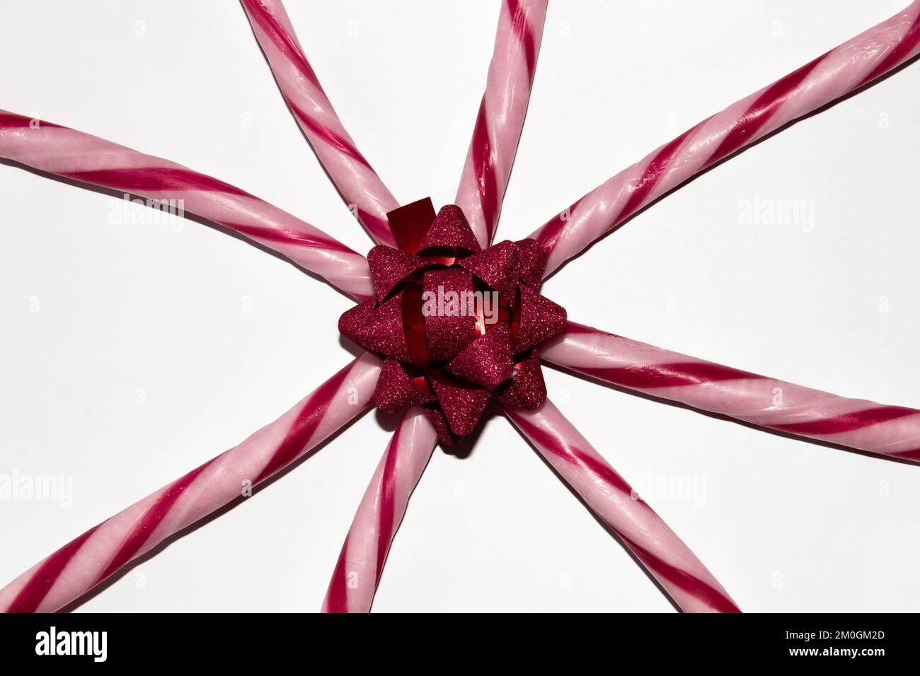 Candy canes with a red bow in the center on white background Stock ...