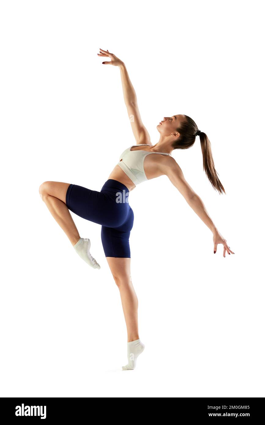 Portrait of young sportive woman training, doing full body exercises ...