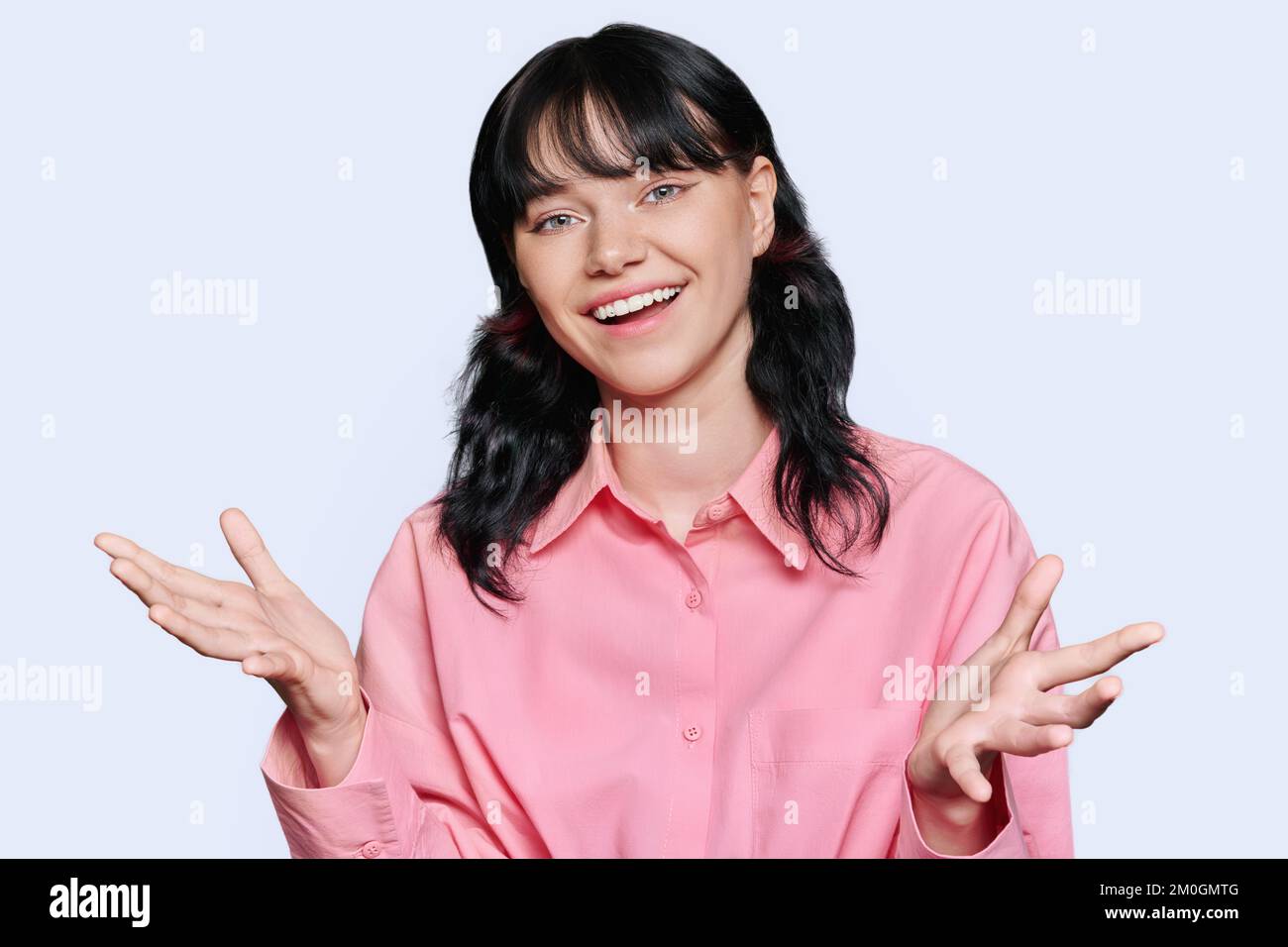 Emotional laughing young female student on white background Stock Photo ...