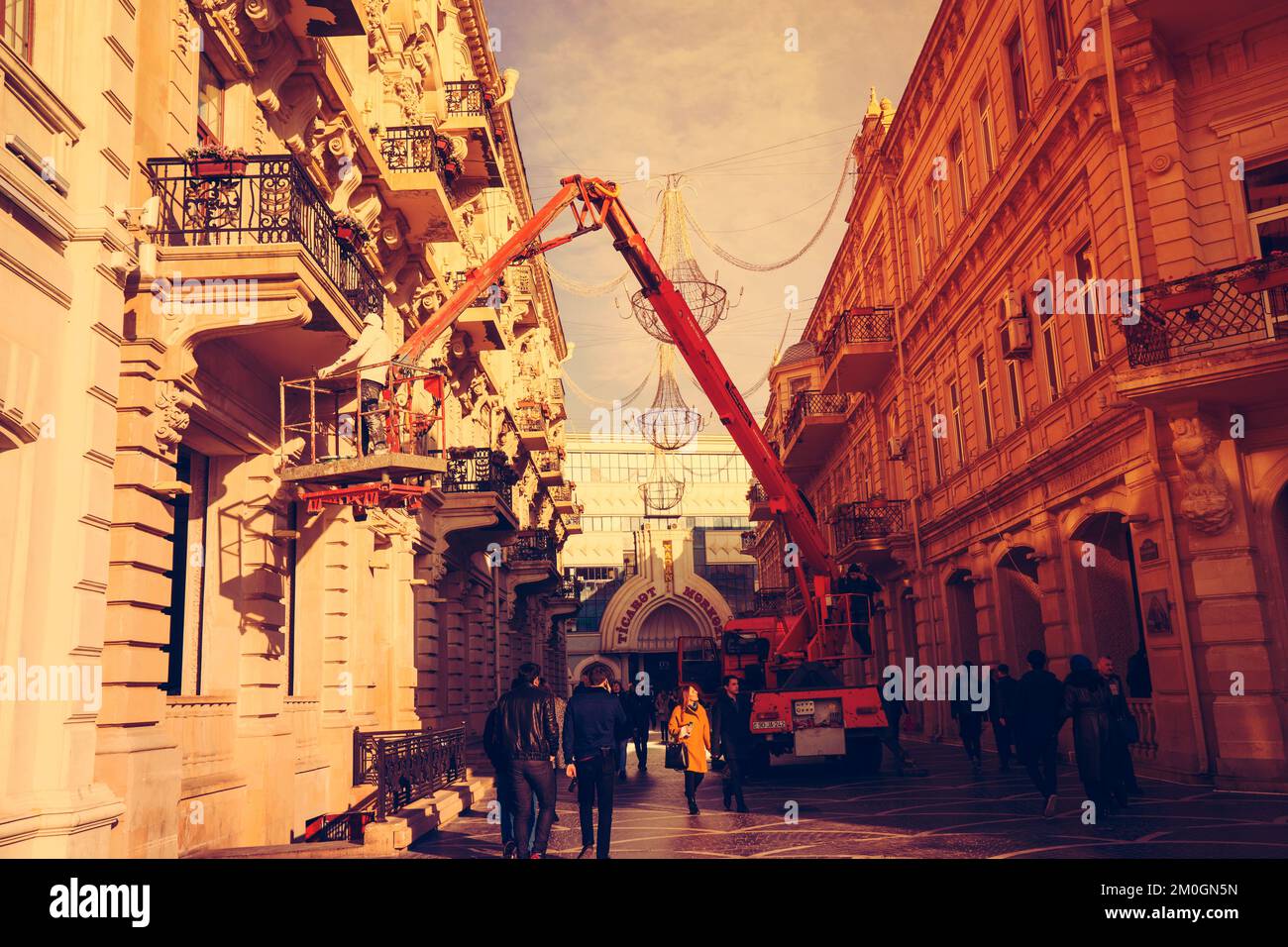construction workers in bucket of crane vehicle for restore and repair ...