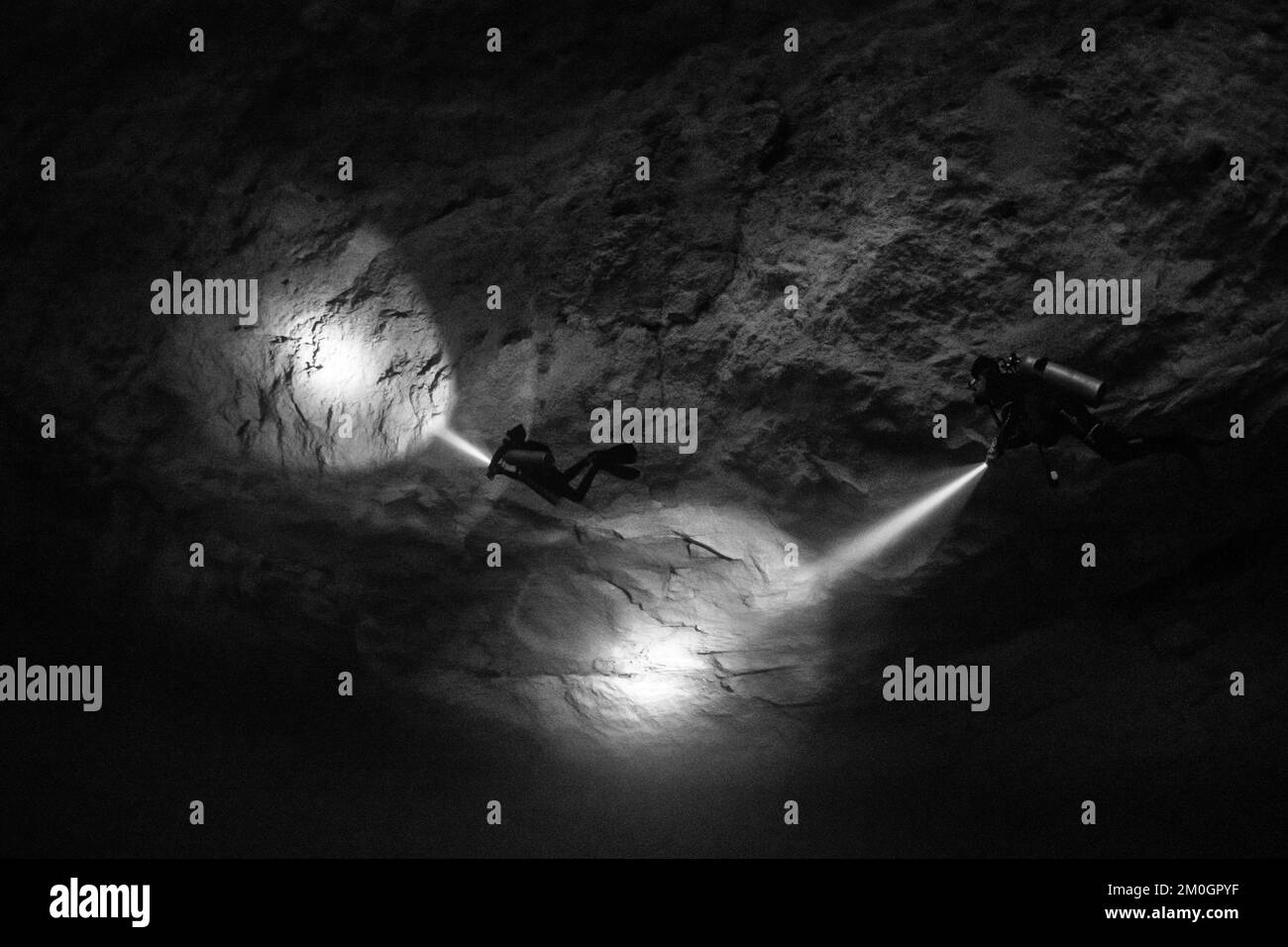 cave diver instructor leading a group of divers in a mexican cenote ...
